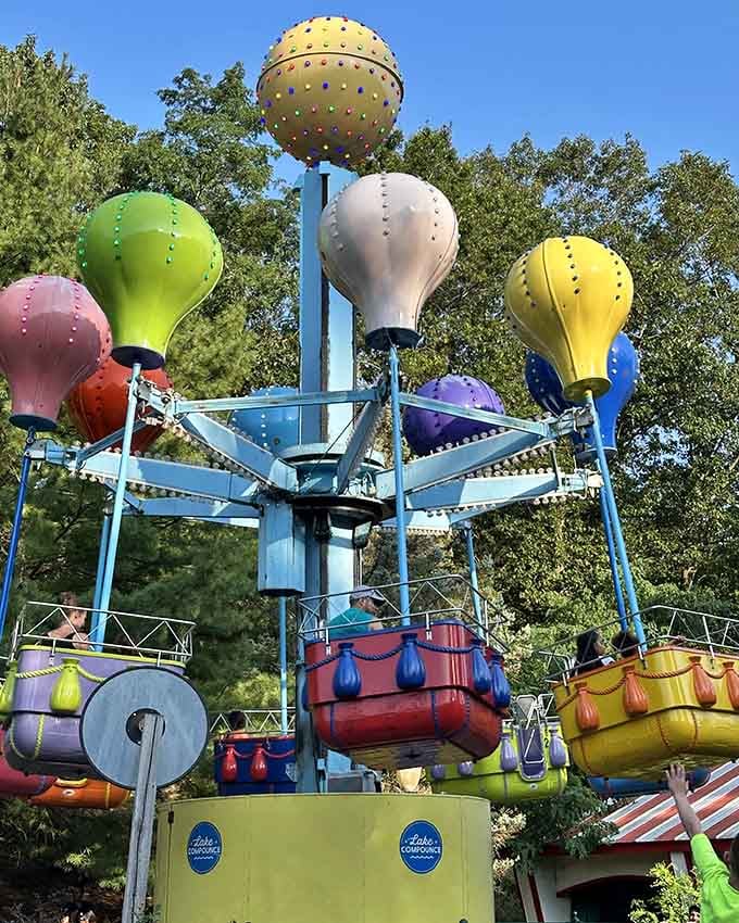 Colorful balloon gondolas spinning gently in the trees. Sometimes the gentlest rides leave the biggest smiles.