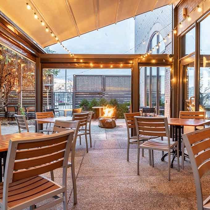String lights, a crackling fire pit, and wooden chairs arranged just so. This patio didn't come from a storybook, it wrote one.