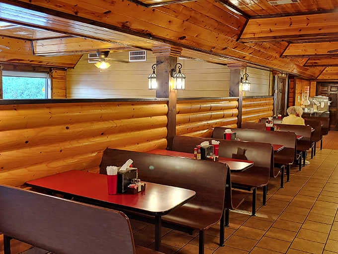 Log cabin walls, warm lantern lights, and a row of booths ready and waiting, this dining room means business in the best way.