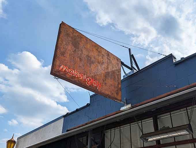 That rusted sign glowing against the sky like a beacon for anyone who appreciates food done right in unexpected places.