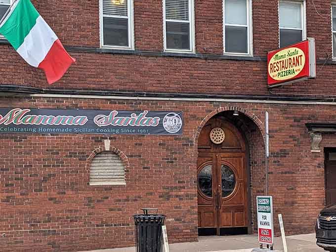 The Italian flag, the arched wooden door, the warm brick, Mama Santa's storefront is Cleveland's Little Italy in one frame.