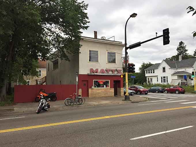 A Harley parked out front, a red MATT'S sign glowing at the corner, and a whole neighborhood knowing exactly where the good stuff is.