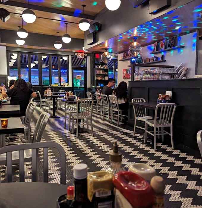 Blue lights, disco energy, and that iconic black and white tile floor. Mom's Kitchen and Bar knows how to set a mood after dark.