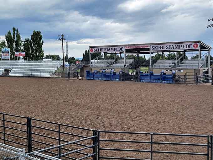 The Ski-Hi Stampede arena sits ready under dramatic Colorado skies, home to what the signage proudly calls Colorado's oldest professional rodeo.