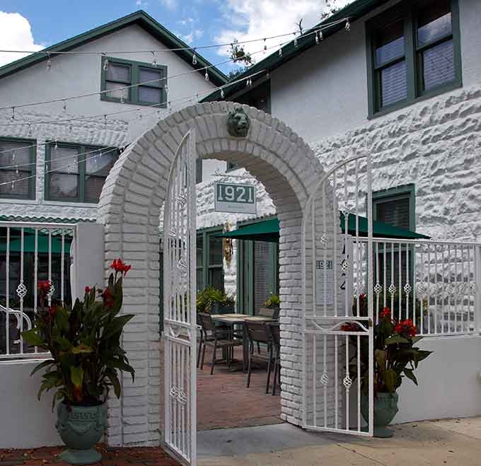 That elegant arched entrance at 1921 Mount Dora practically whispers, "Come in, sit down, and stay a while."