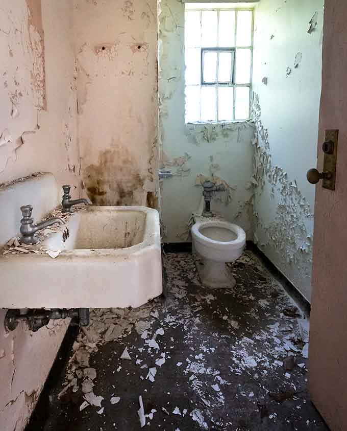 Peeling paint, a cracked sink, and a barred window make this bathroom the least relaxing spa experience imaginable.