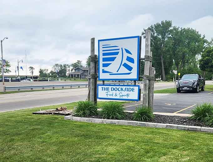 That bold blue-and-white sign standing tall near the road is basically a lighthouse for hungry travelers who made the right turn.