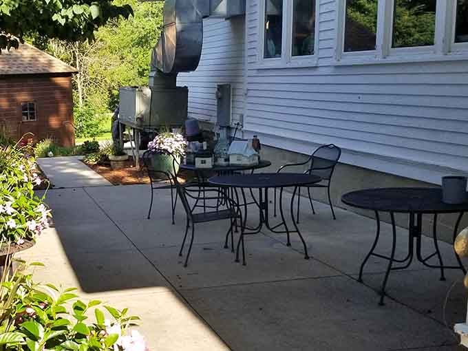 A quiet patio tucked behind the cafe, surrounded by flowers. Outdoor breakfast in Mantorville is a very underrated life choice.