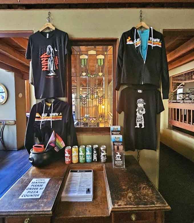 Nina on a t-shirt, craft beer in a can, and Old Town merch worth taking home. The ghost has excellent branding.