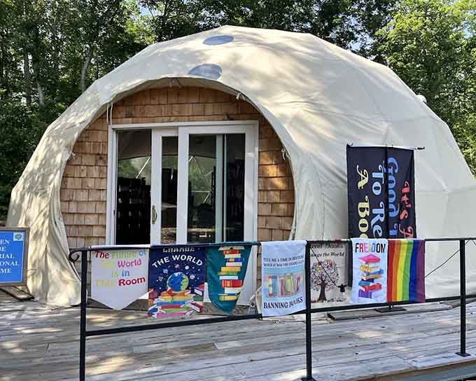 A geodome covered in book-loving banners standing proudly outdoors, because at Pandemonium, even the architecture has something important to say.