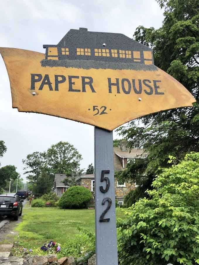 A cheerful yellow sign pointing the way to one of Massachusetts' most wonderfully strange and unforgettable hidden treasures.