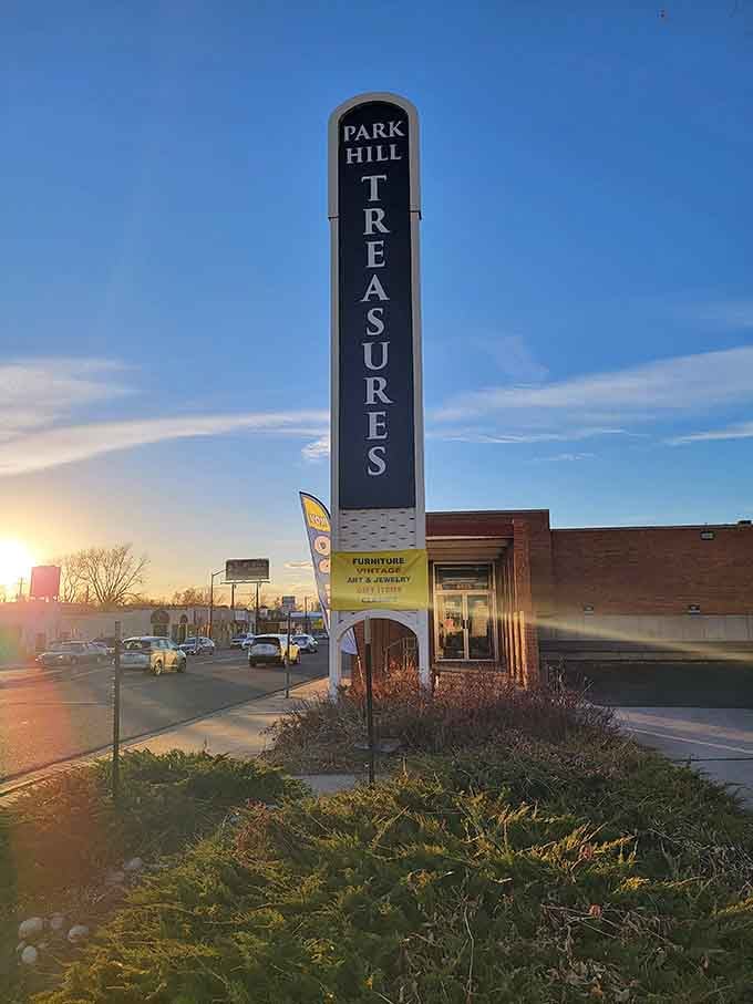 At golden hour, that tall Park Hill Treasures sign looks less like a store marker and more like an invitation from the universe.