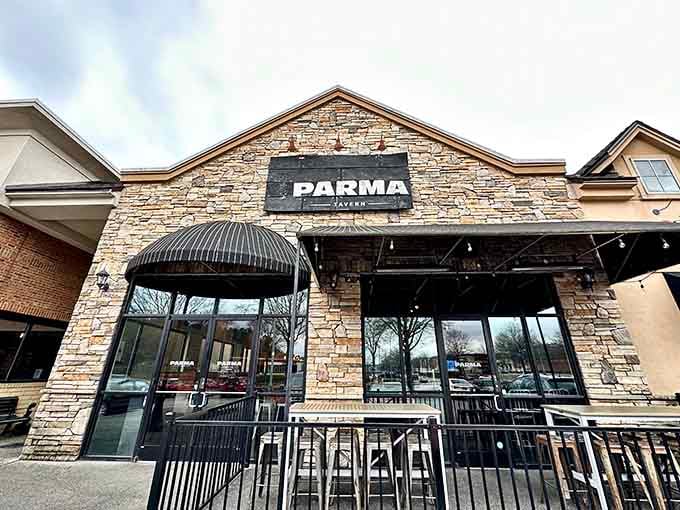 The stone facade and dark awnings of Parma Tavern, a strip mall exterior hiding something truly worth finding.