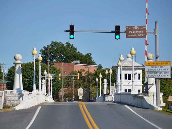 The ornate white bridge over the Pocomoke Scenic River is the kind of entrance that makes you slow down and actually arrive.