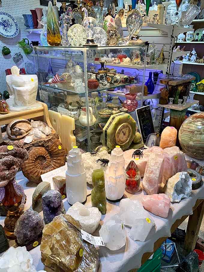Crystals, minerals, and art glass share a table, creating a display that looks like nature and craftsmanship had a very productive meeting.