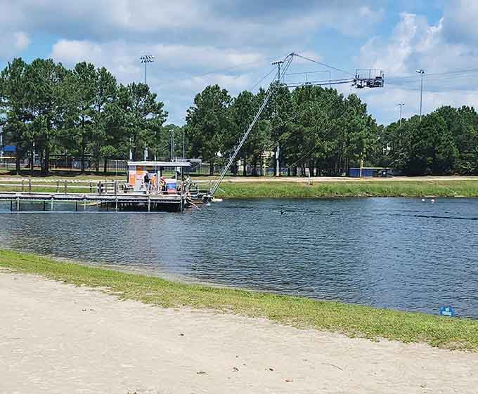 The cable tower system stretches across the lake, pulling riders through their wakeboarding adventures with mechanical precision.