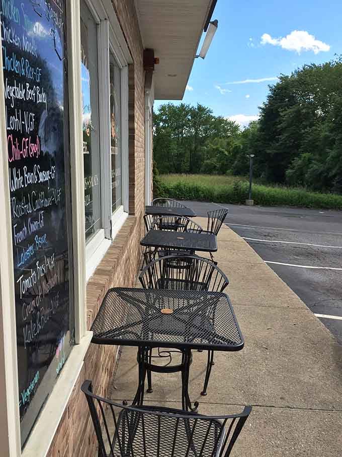 Iron tables, open sky, and a chalkboard menu visible right through the window. Outdoor dining at Soup Thyme is its own kind of perfect.