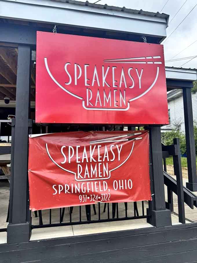 Two red signs, one clear message: Speakeasy Ramen, Springfield, Ohio, and a phone number worth saving in your contacts.