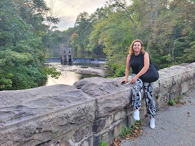 Perched on the stone bridge with the spillway behind her. Honestly, this is the correct way to spend a Saturday.