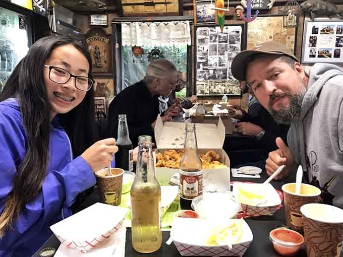 Two happy diners surrounded by chowder cups and fried seafood inside Stowe's quirky dining room says everything worth saying.