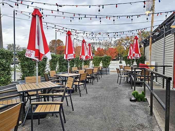 String lights, Coca-Cola umbrellas, and autumn trees in the background. The patio at Tay's is genuinely charming.