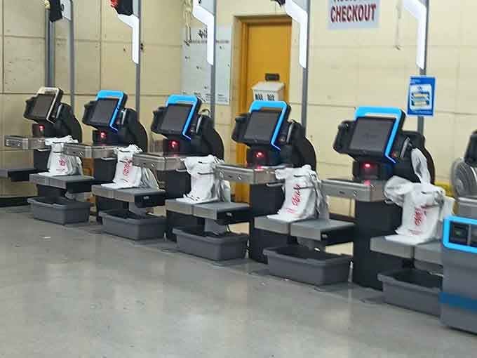 A clean row of self-checkout stations, because even a great thrift haul deserves a smooth finish.