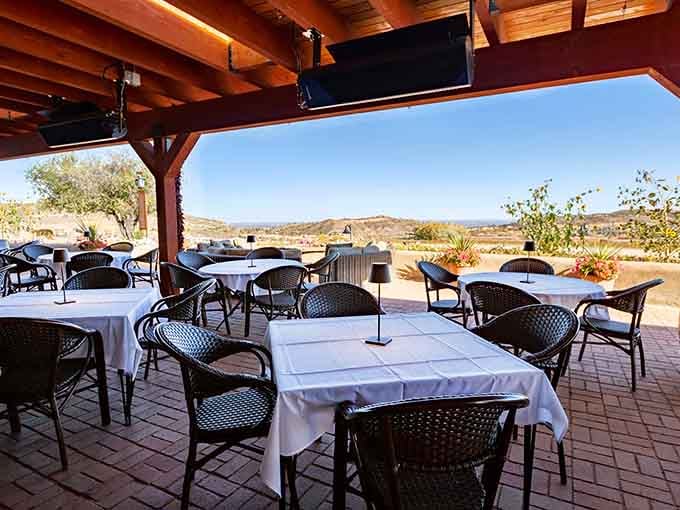 An open patio with sweeping Colorado hill views and white tablecloths. Fresh air and good food are a timeless combination.