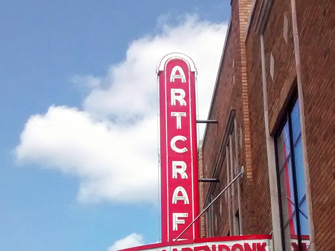 That bold red vertical sign against a blue Indiana sky is a photograph that practically takes itself.