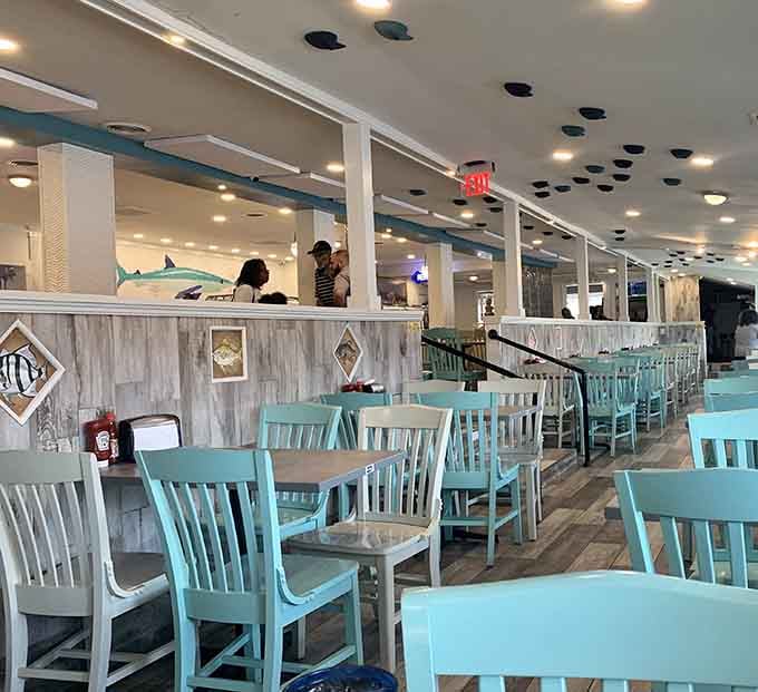 Turquoise chairs and weathered wood create that beachy vibe without a single grain of actual sand involved.