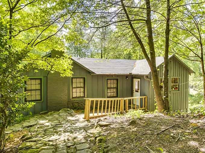 Tucked into the trees like it's been there forever, this little green structure adds one more layer of mystery to the property