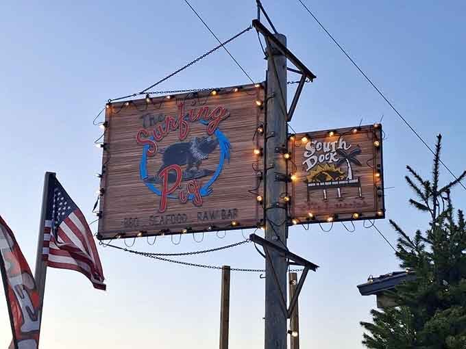 The Surfing Pig sign glowing at dusk, lit up like a beacon for anyone who knows that great BBQ is worth finding.