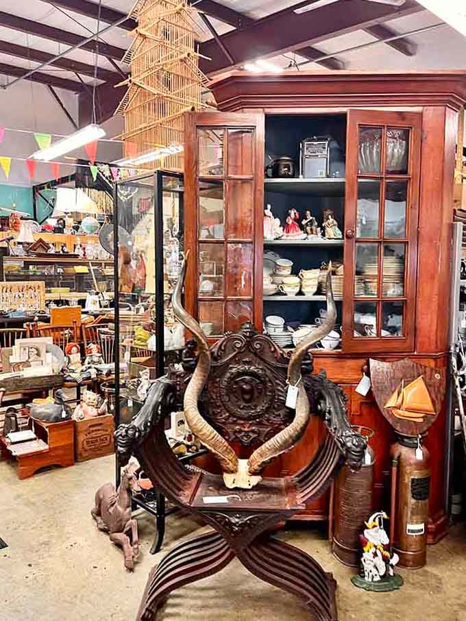 An ornate horn chair in front of a towering corner cabinet, this is the furniture equivalent of a conversation starter.