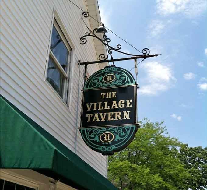 That classic hanging sign against blue sky promises exactly what it delivers: honest food, cold drinks, and genuine hospitality inside.