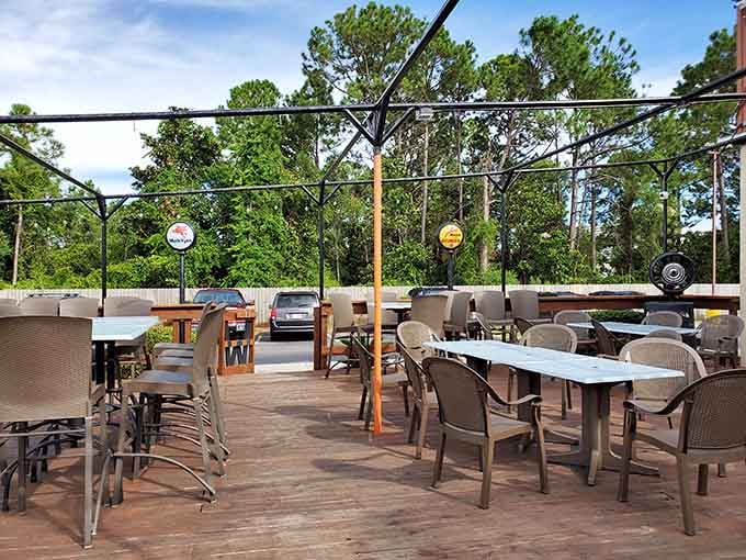 The open-air patio with tall pines in the background, fresh air, good food, and zero reasons to rush anywhere.