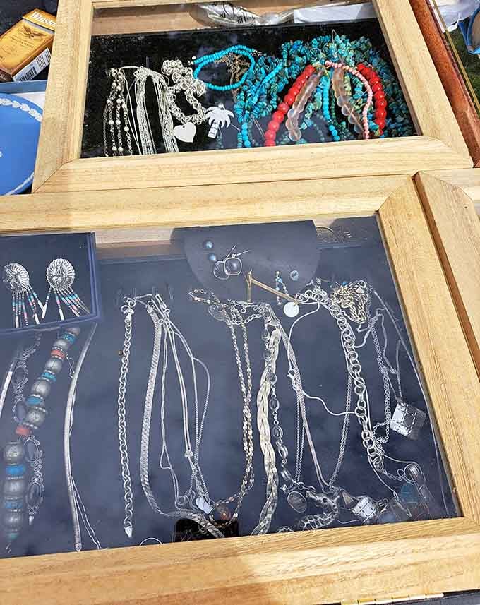 Silver chains, turquoise beads, and coral strands tucked behind glass. Someone's next favorite necklace is hiding right here.