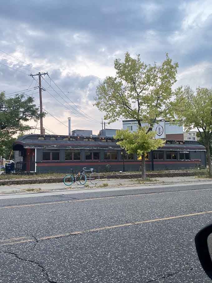 From across the street at golden hour, this railroad car looks like a place where something genuinely wonderful is happening inside.