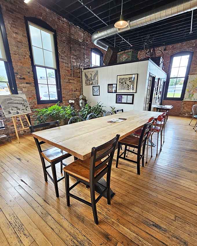 A long communal table, warm light, and framed artwork on the walls. This is what a bakery looks like when it truly loves its community.