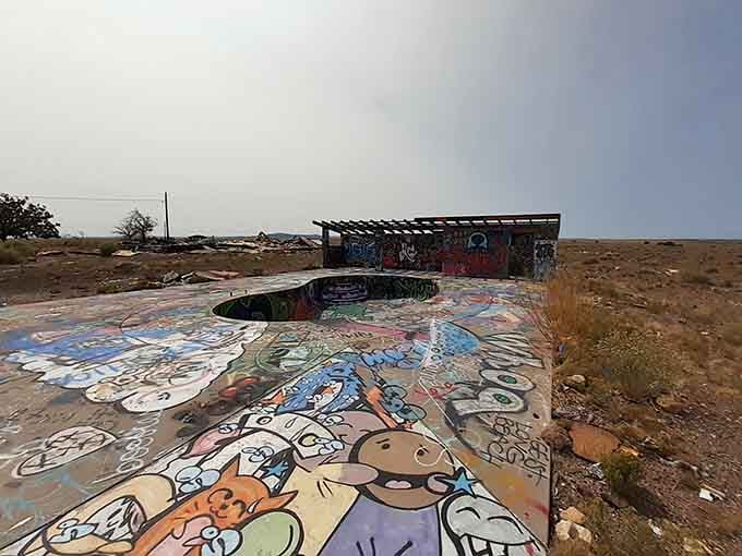 Even the abandoned pool area became a canvas, because apparently nothing here escapes the spray paint.