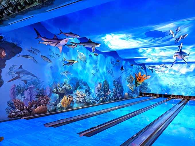 Floor to ceiling sharks, painted waves, and vivid coral stretching across every wall, these bowling lanes belong in an art museum.