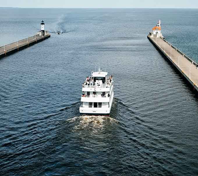 The Vista Star heading out through the harbor channel, lighthouses on both sides, open lake straight ahead. Go.