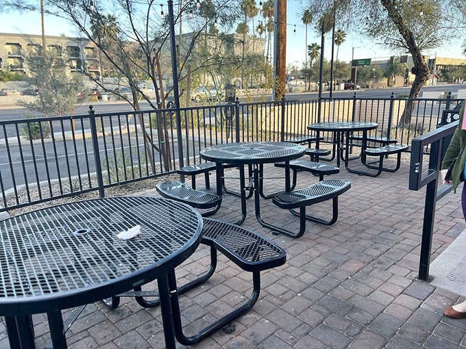 Black metal patio tables and brick pavers offer the perfect spot for outdoor donut demolition.