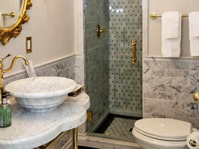 Marble vessel sink, gold fixtures, and mosaic tile. Even the bathroom here makes you feel like royalty.