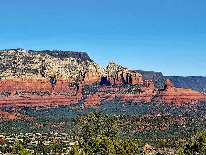 Sedona's red rock towers glow like embers under a wide, cloudless Arizona sky.