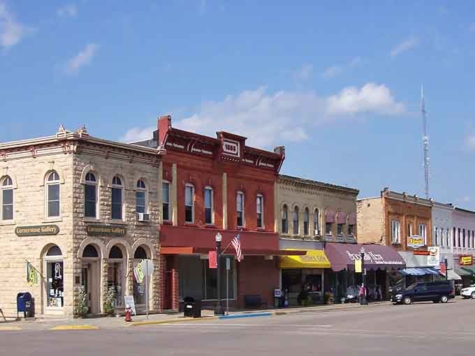 These colorful storefronts line up like a rainbow of small-town charm under perfect blue skies.