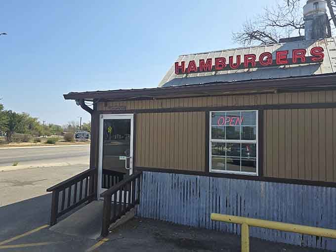 That red neon "HAMBURGERS" sign against a clear Texas sky is basically a delicious billboard for your stomach.