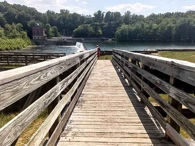This weathered boardwalk leads straight to history, with a cascading weir and old brick building framing the Potomac perfectly.
