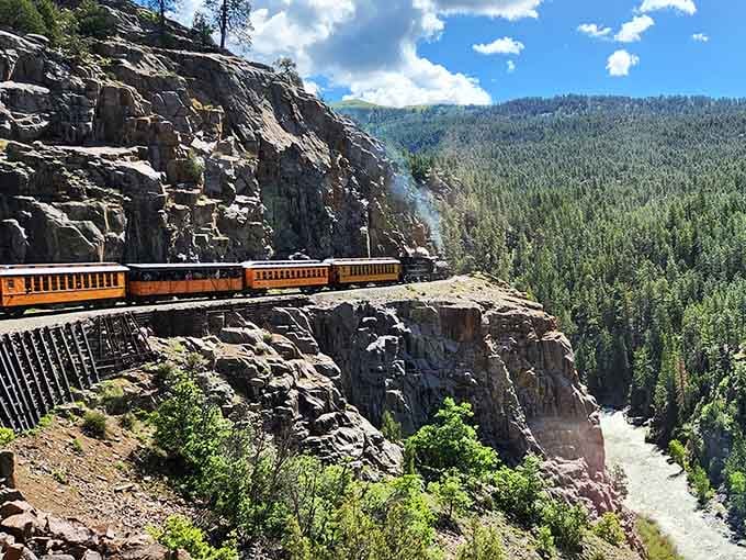 Orange cars hugging sheer canyon walls above a rushing river &mdash; this is Colorado showing off shamelessly.