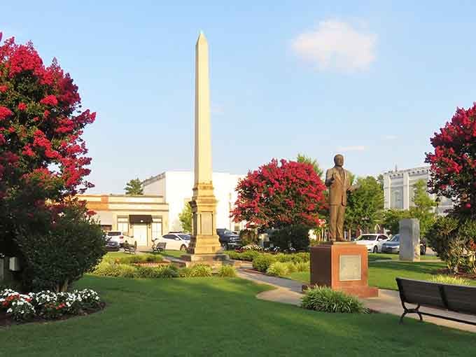 Blooming crepe myrtles frame this stately obelisk like nature's own welcome committee to Edgefield.