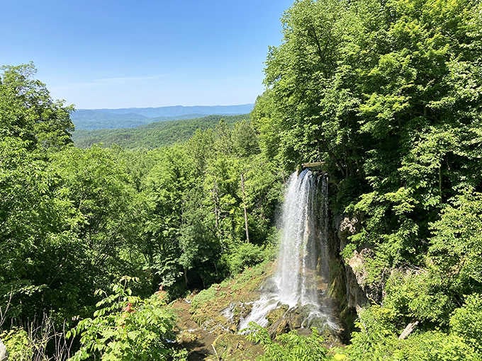 Mother Nature showing off with an 80-foot ribbon of water framed by endless mountain views and summer greenery.