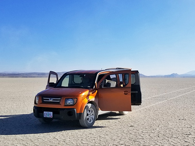 Your trusty vehicle becomes a speck against endless white, proving size is relative in nature's grandest gallery.
